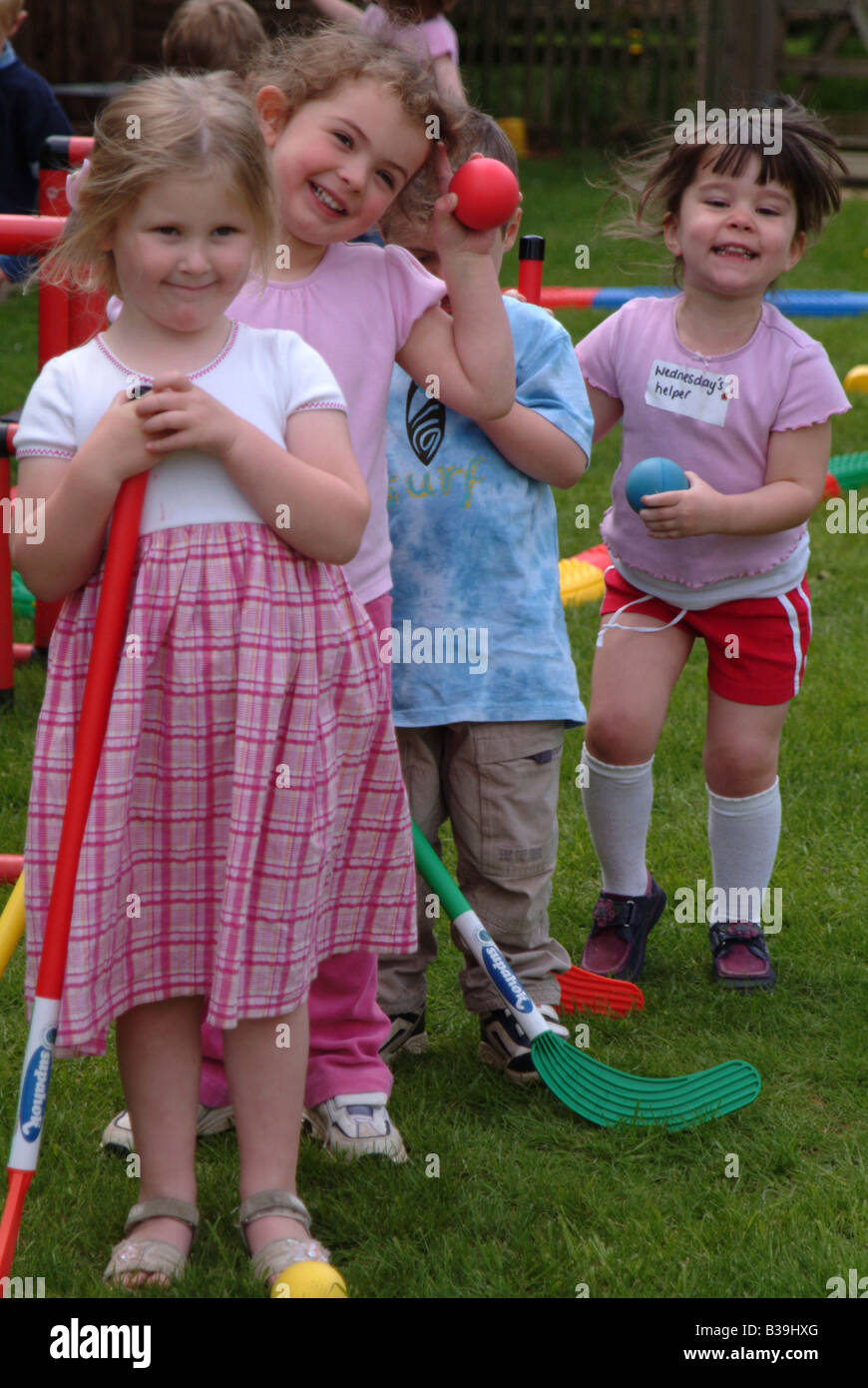 Group of children playing with plastic hockey sticks Stock Photo - Alamy