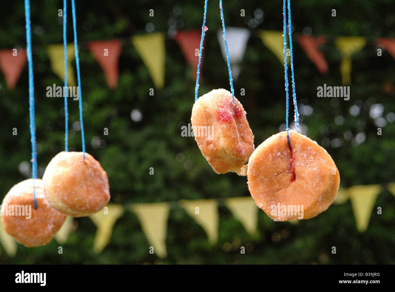 Close-up of doughnuts hanging on a string Stock Photo - Alamy