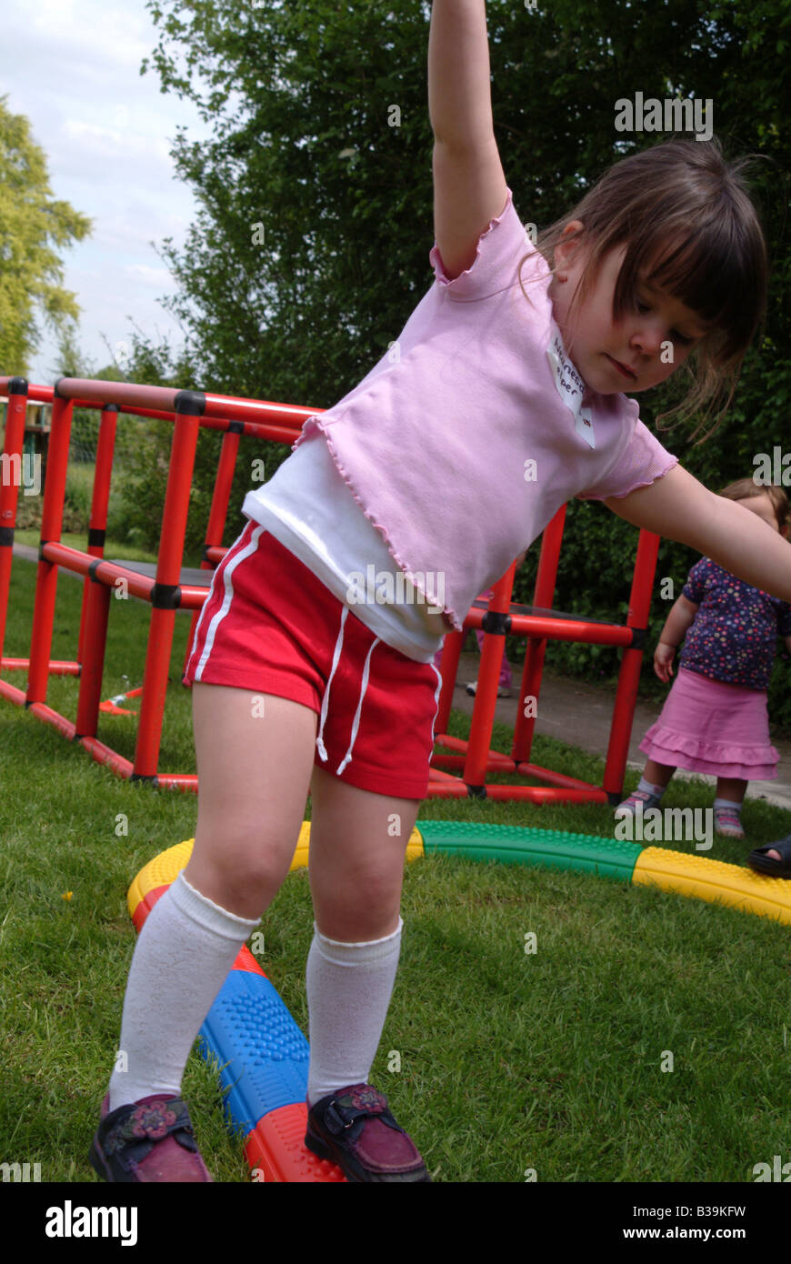 Little girl balancing Stock Photo - Alamy