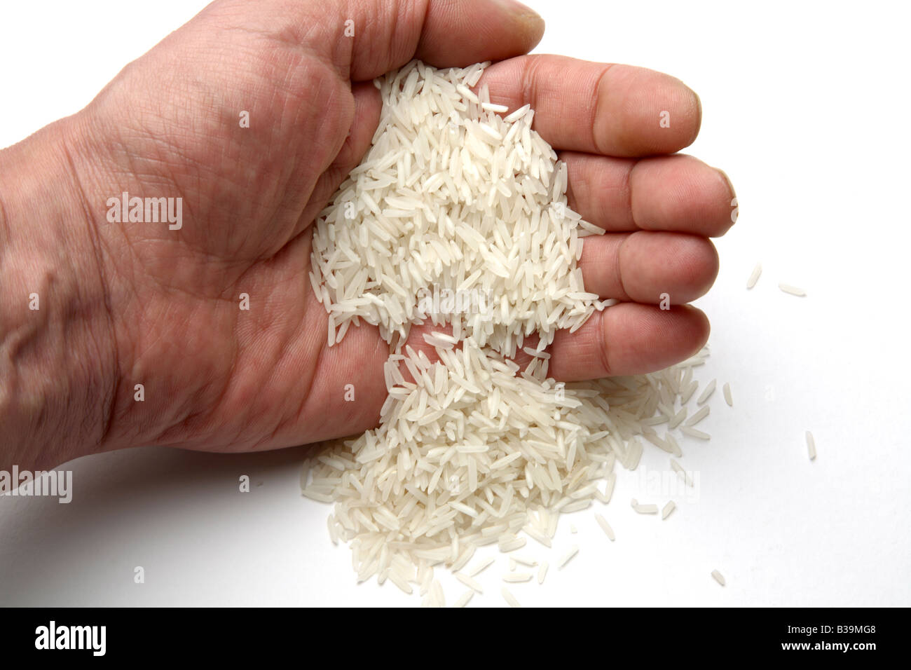 Rice pouring from a hand Stock Photo - Alamy