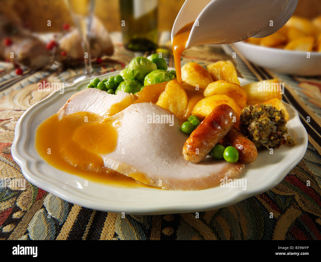 Traditional roast turkey Christmas dinner with all the trimmings and roast potatoes, plated ...