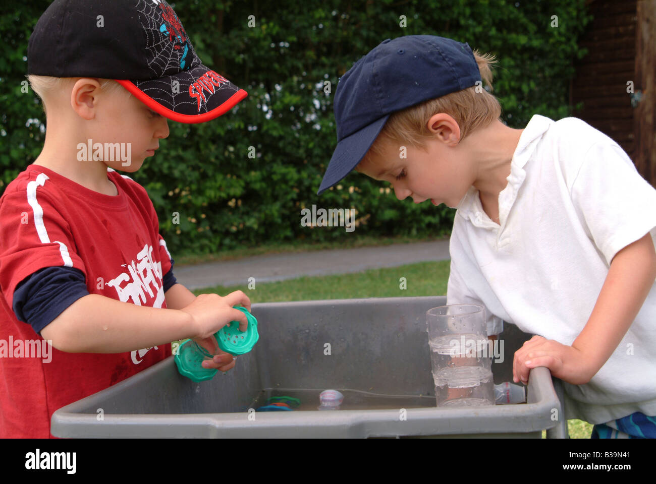 Nursery children playing with water Stock Photo - Alamy