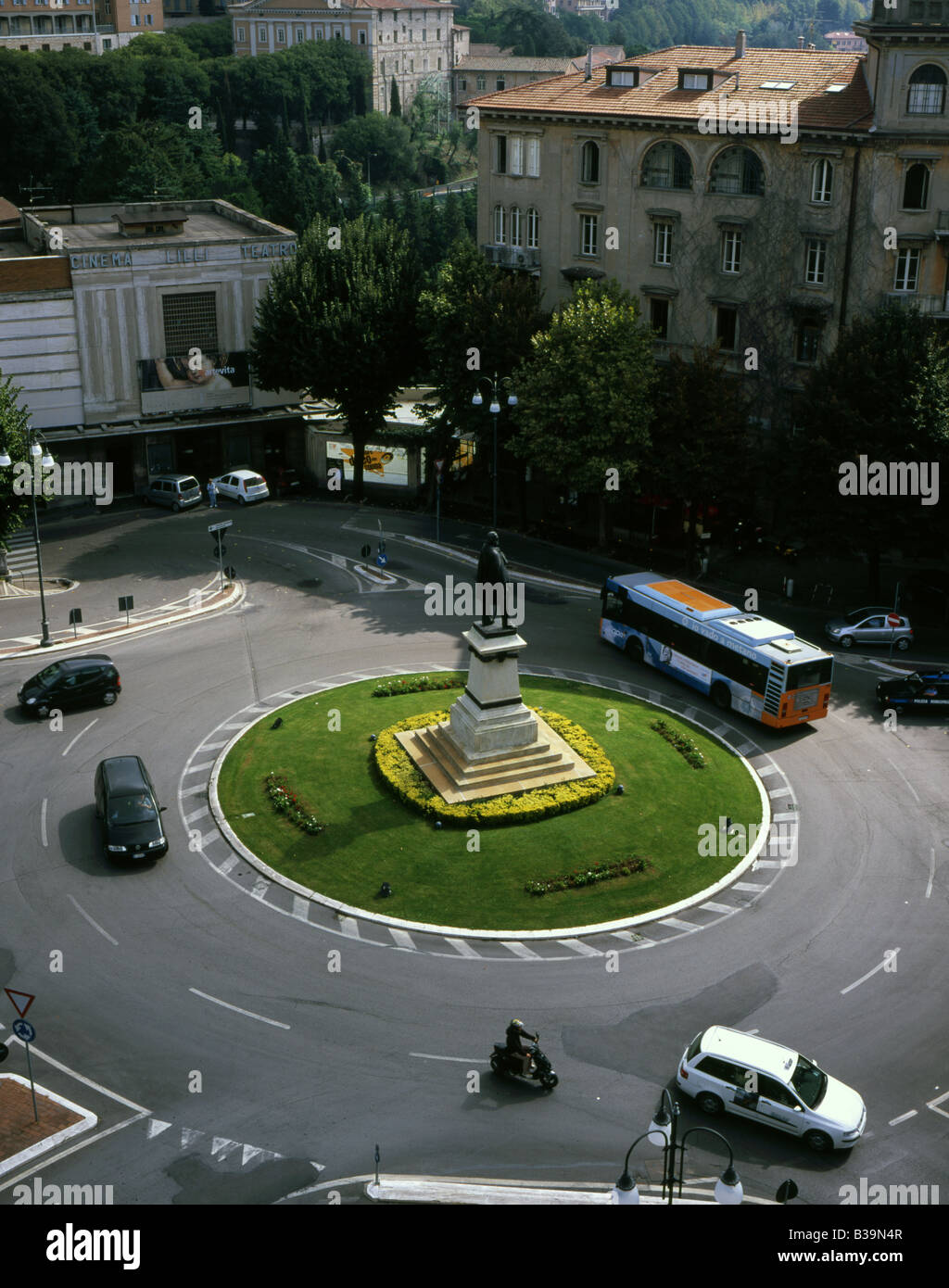 Bus driving round a roundabout, with a statue of Garibaldi in the ...