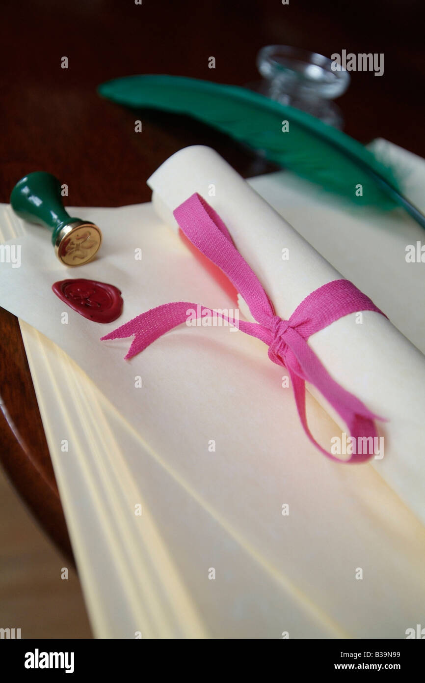 Scroll of legal documents bound in pink ribbon with wax seals and a ...