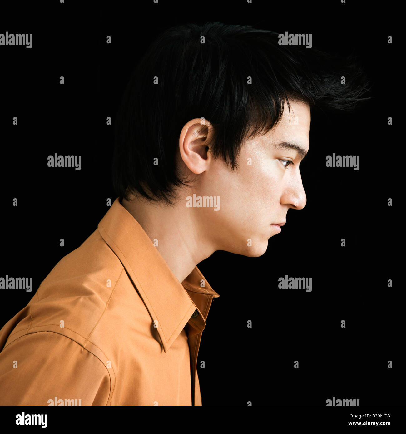 Side profile of serious Asian young man Stock Photo - Alamy