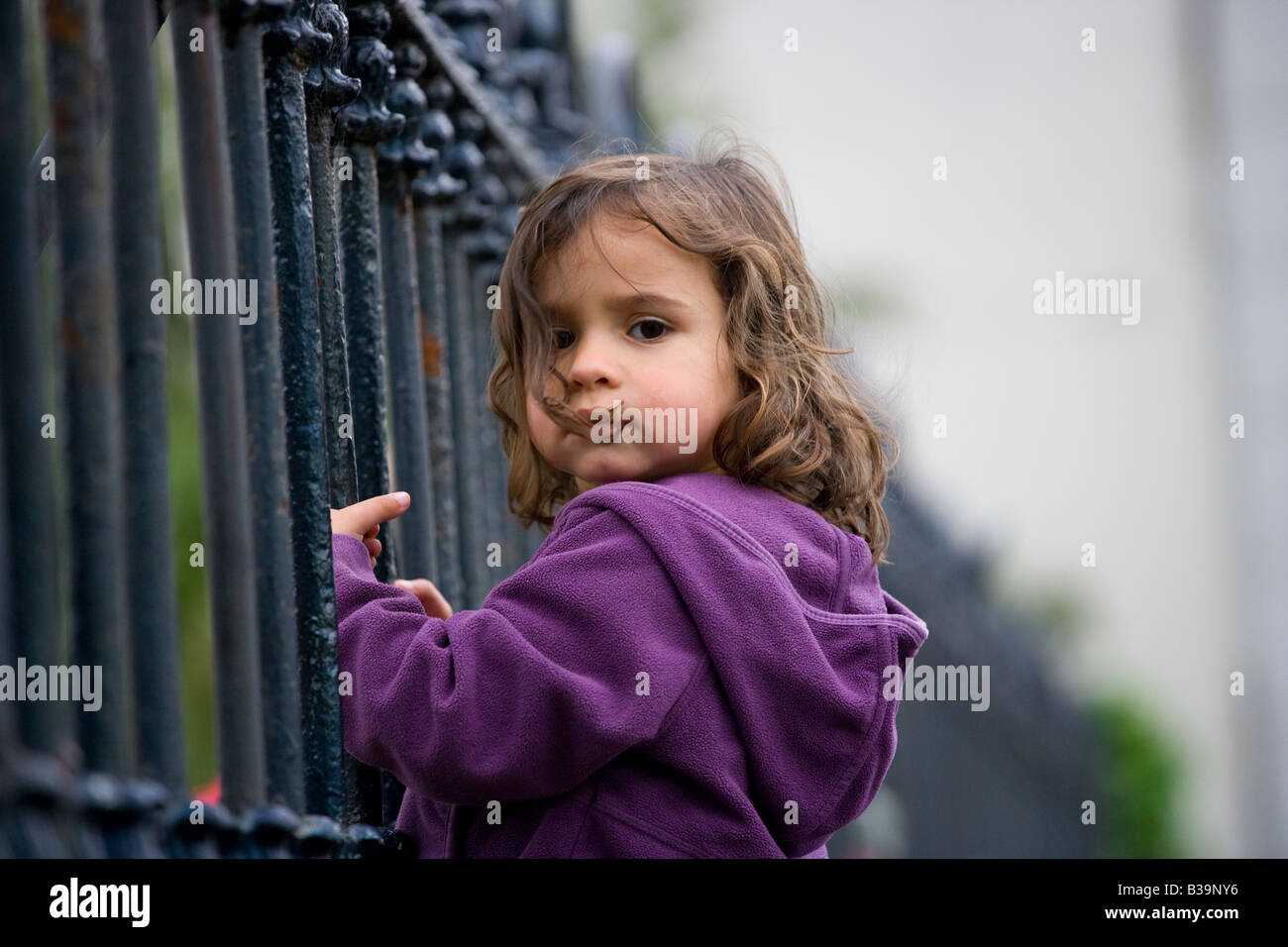 young child holding onto railings Stock Photo - Alamy