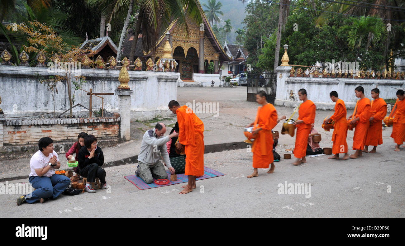 Monks receiving alms Stock Photo - Alamy