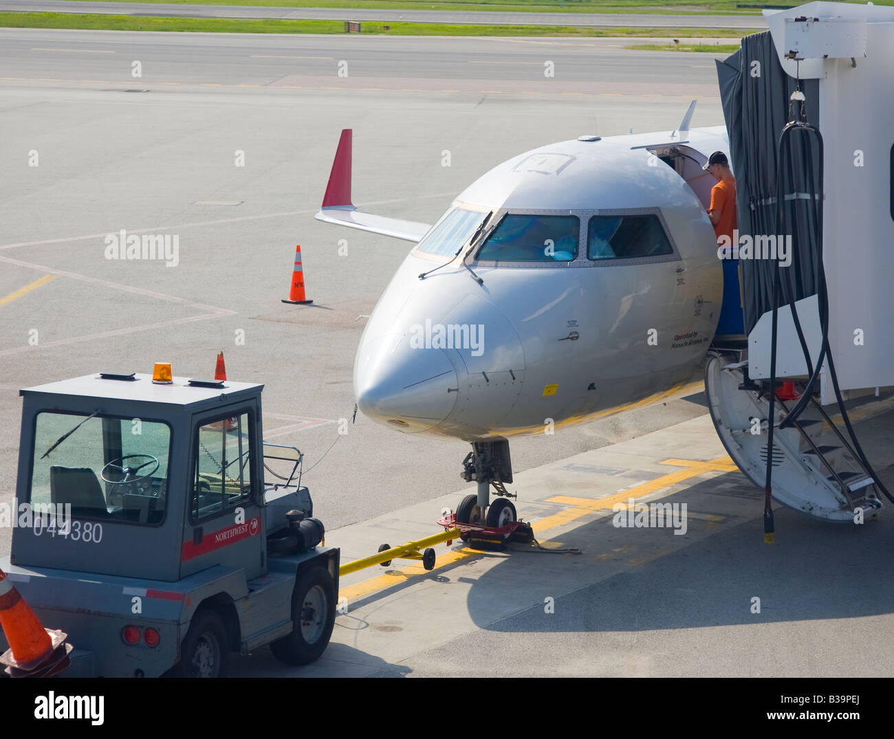 Passenger entering a jet aircraft Stock Photo - Alamy