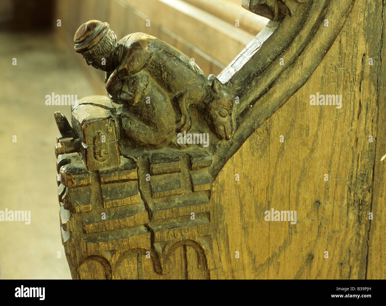 Medieval bench end Man in Stocks with stolen pig hog across shoulder ...