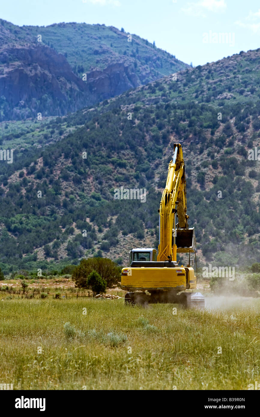 Photo of a large excavator tracked backhoe working and helping to build ...