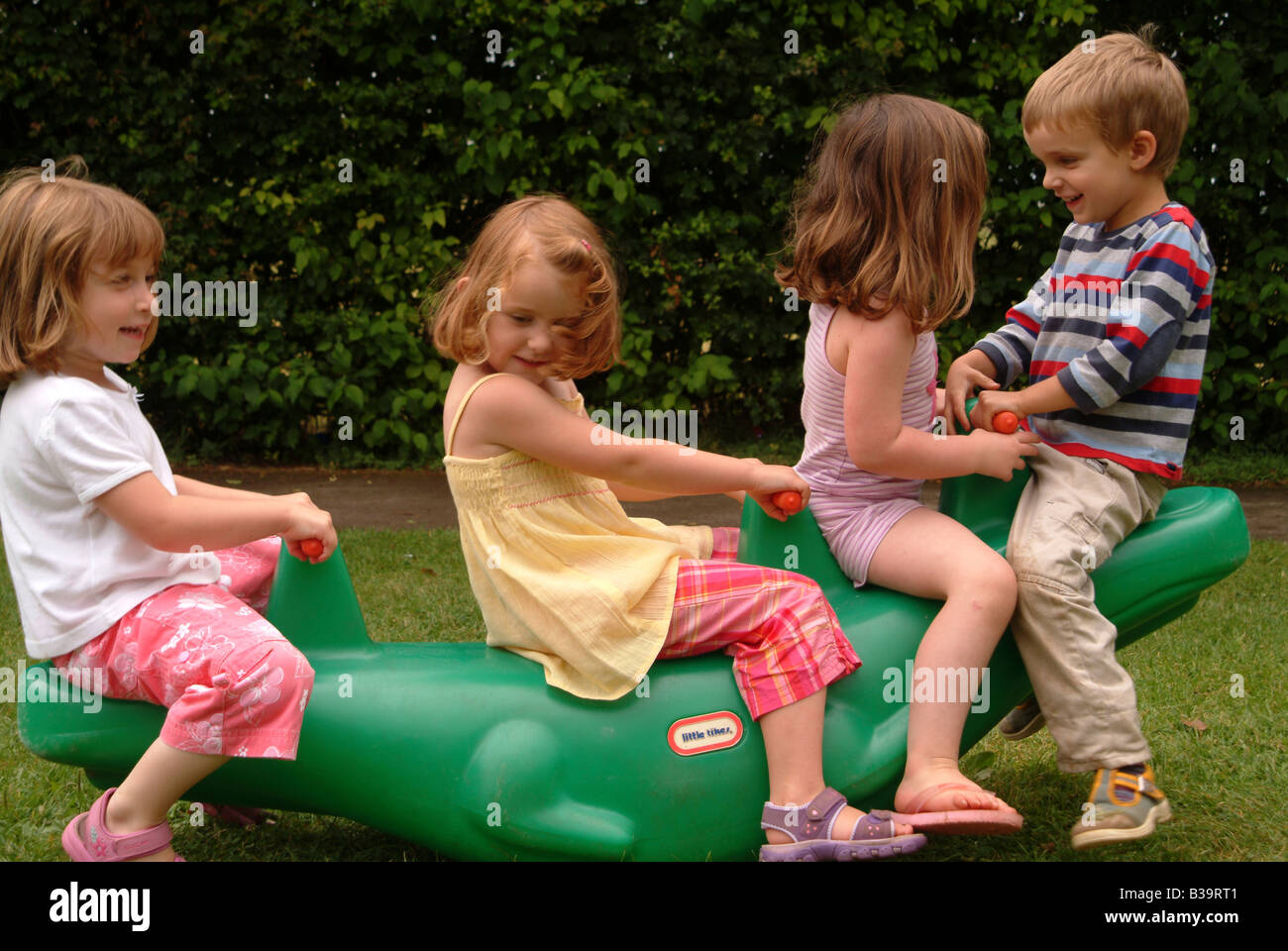 Children playing on a plastic rocking crocodile Stock Photo - Alamy