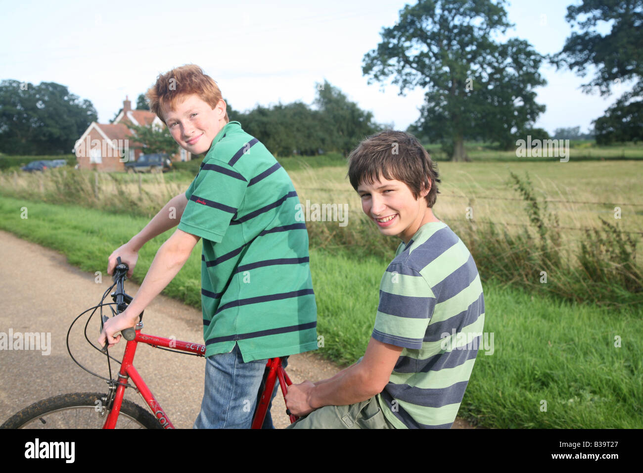 Two teenage boys on a bicycle Stock Photo - Alamy