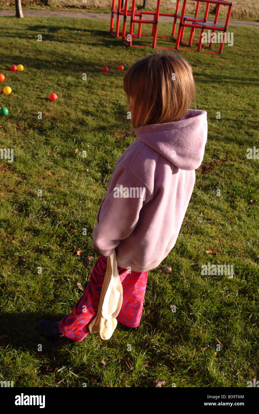 Child standing alone in playground hi-res stock photography and images ...