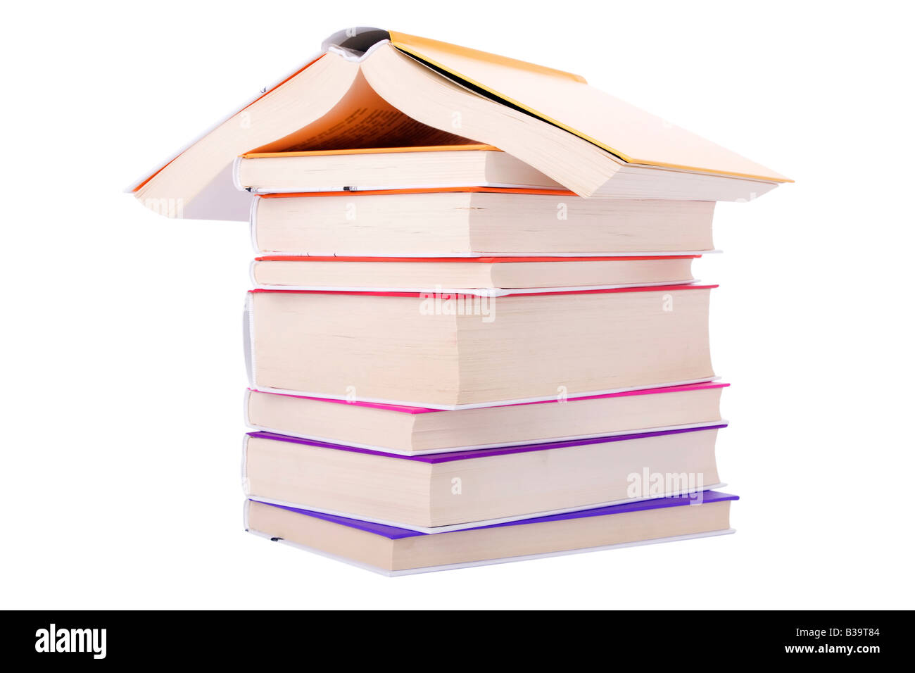 House made with books piled isolated on white background / book roof ...