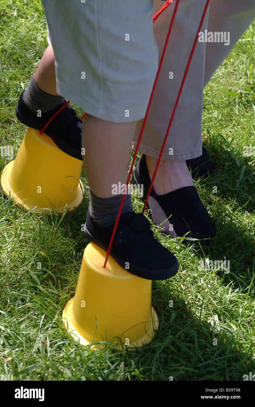 Close-up of child's feet on stilts Stock Photo - Alamy