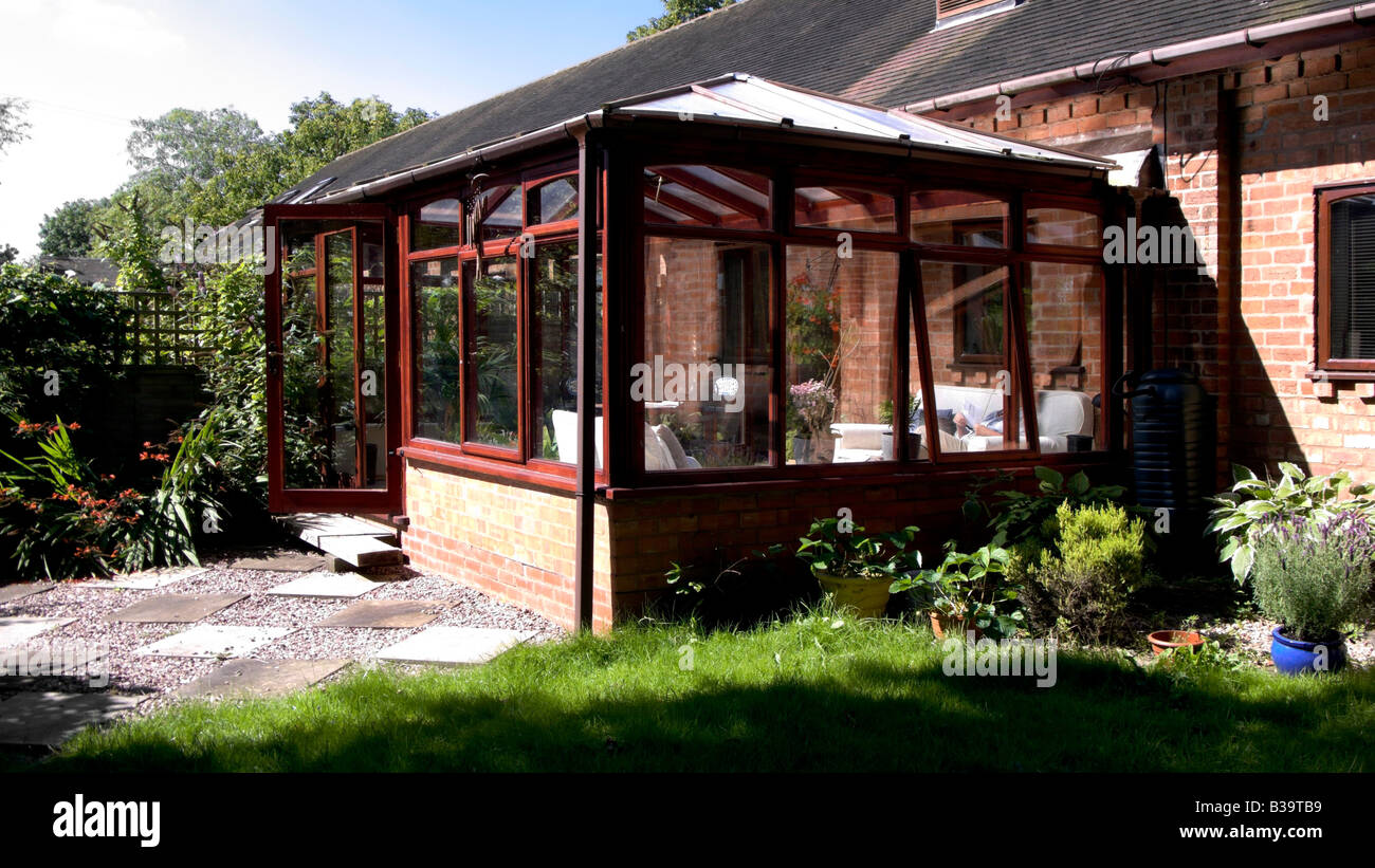 conservatory tables chairs plants room in house next to garden Stock ...
