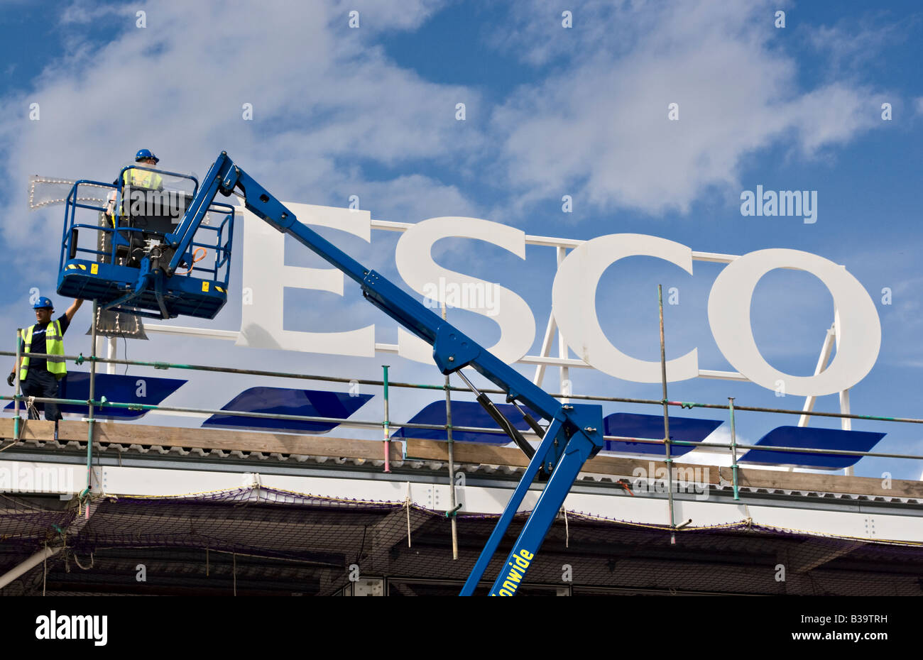 Tesco sign installation London Stock Photo - Alamy