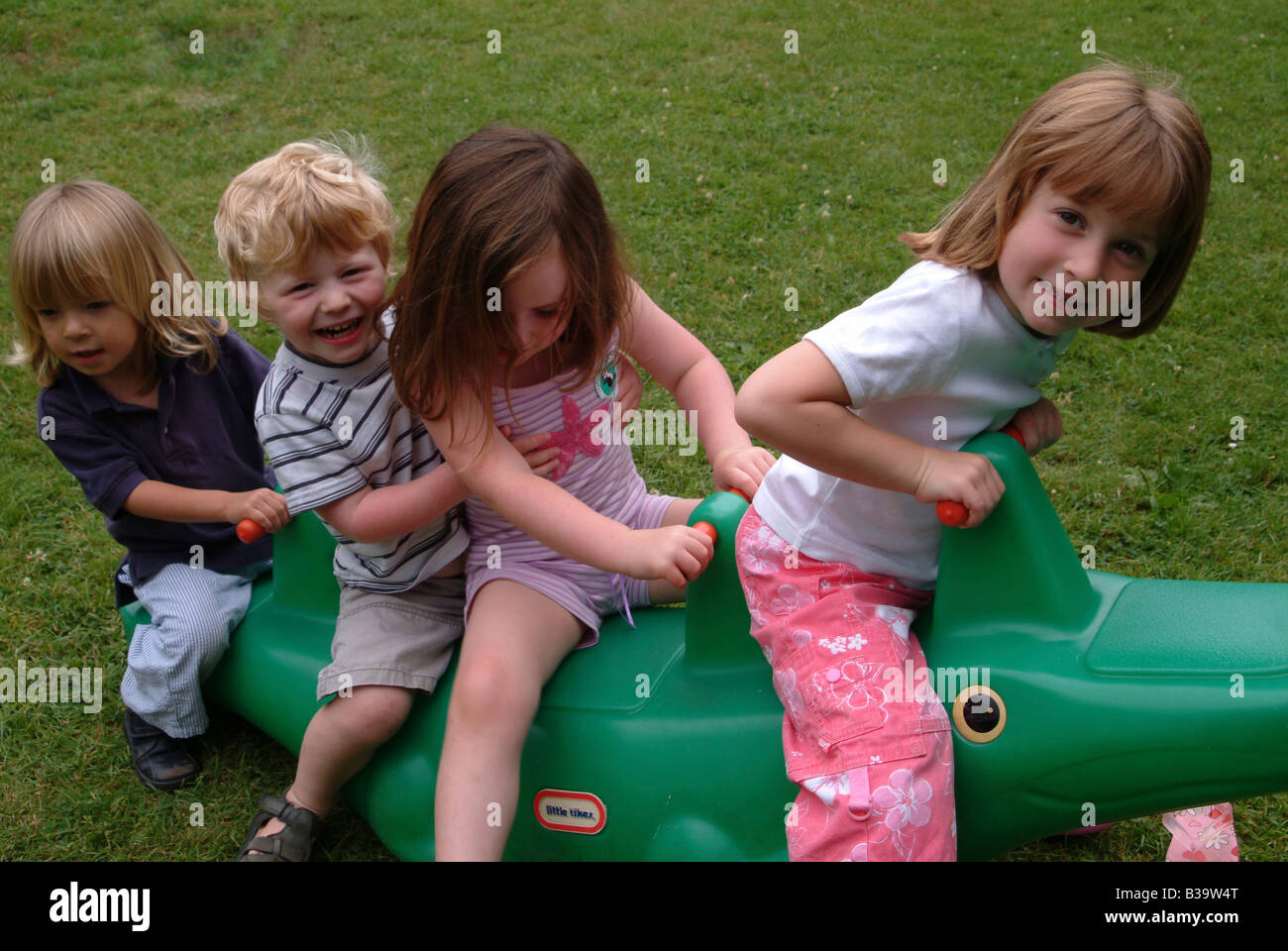 Children playing on a plastic rocking crocodile Stock Photo - Alamy