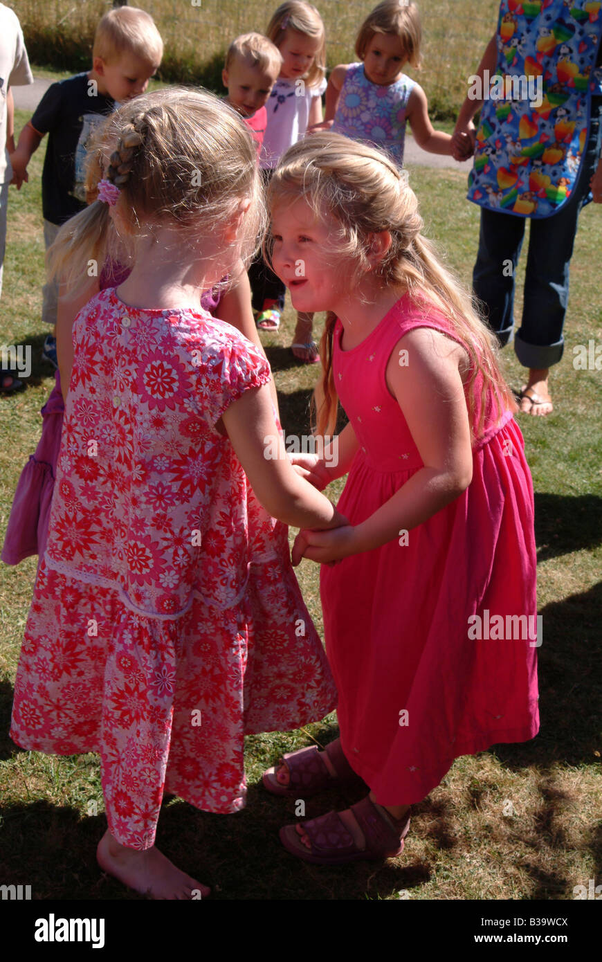 Nursery children playing and talking outdoors Stock Photo - Alamy