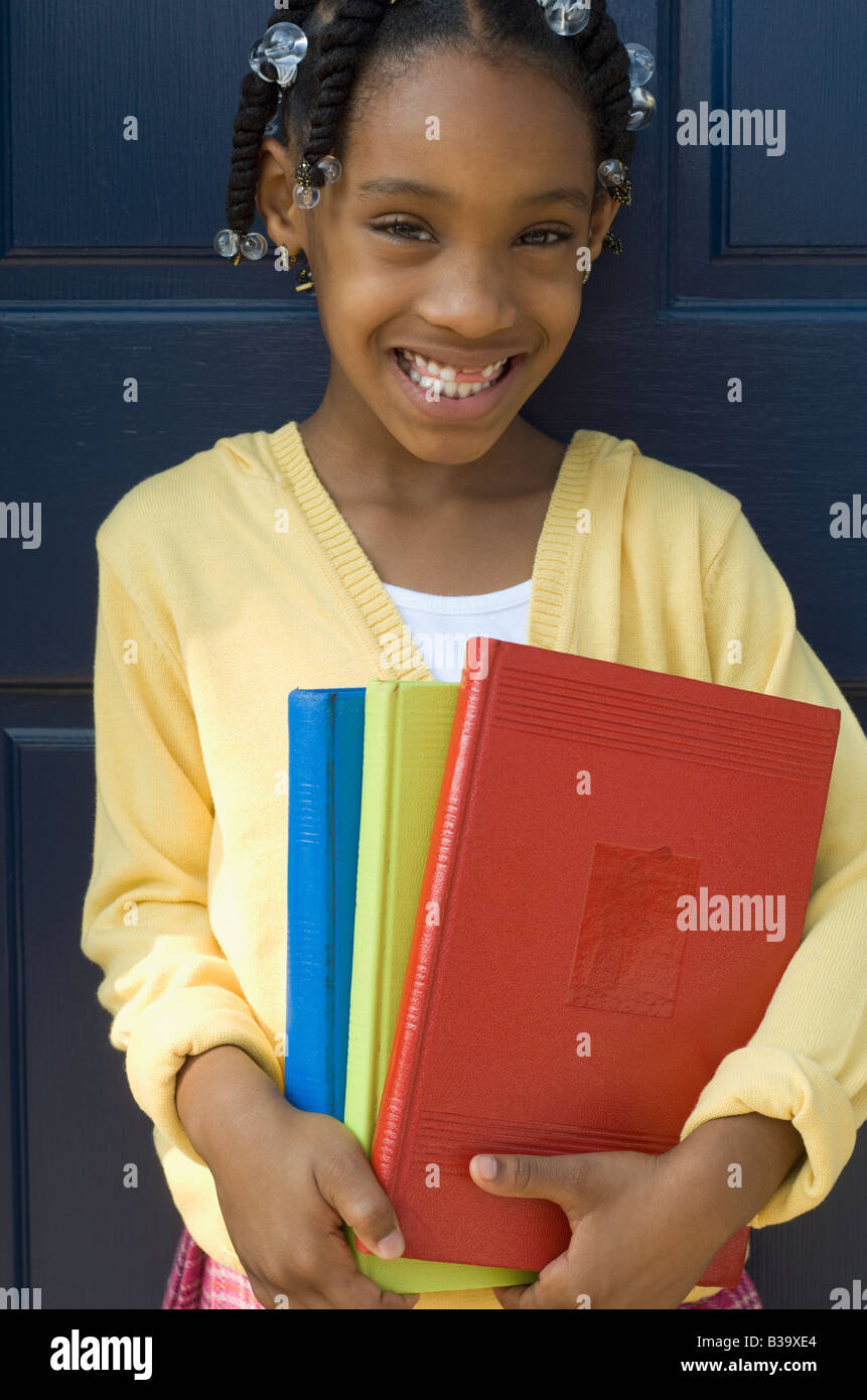 African girl holding school books Stock Photo - Alamy