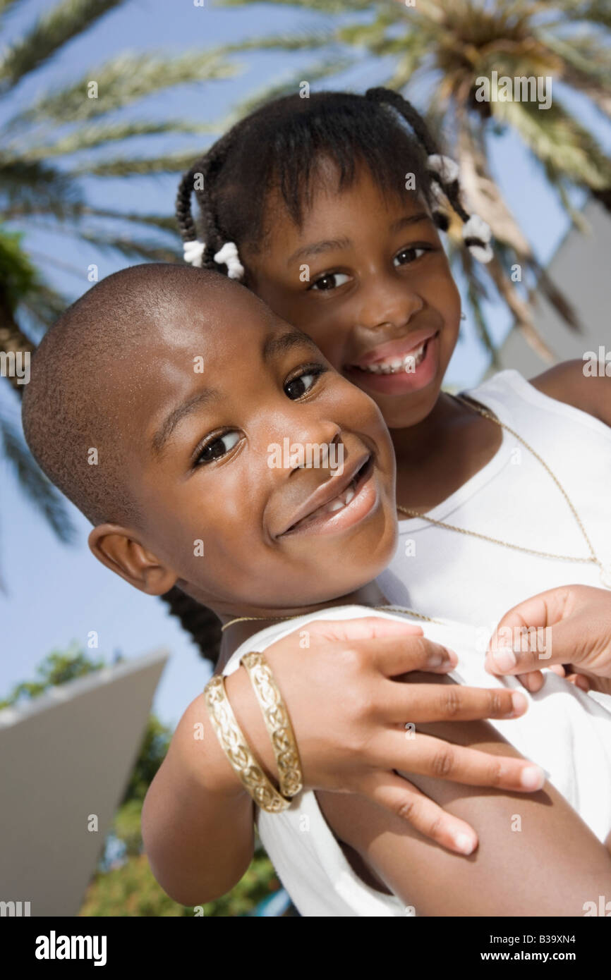 African brother and sister hugging Stock Photo - Alamy