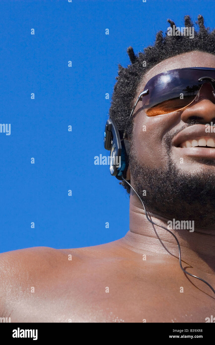 African man listening to headphones Stock Photo - Alamy