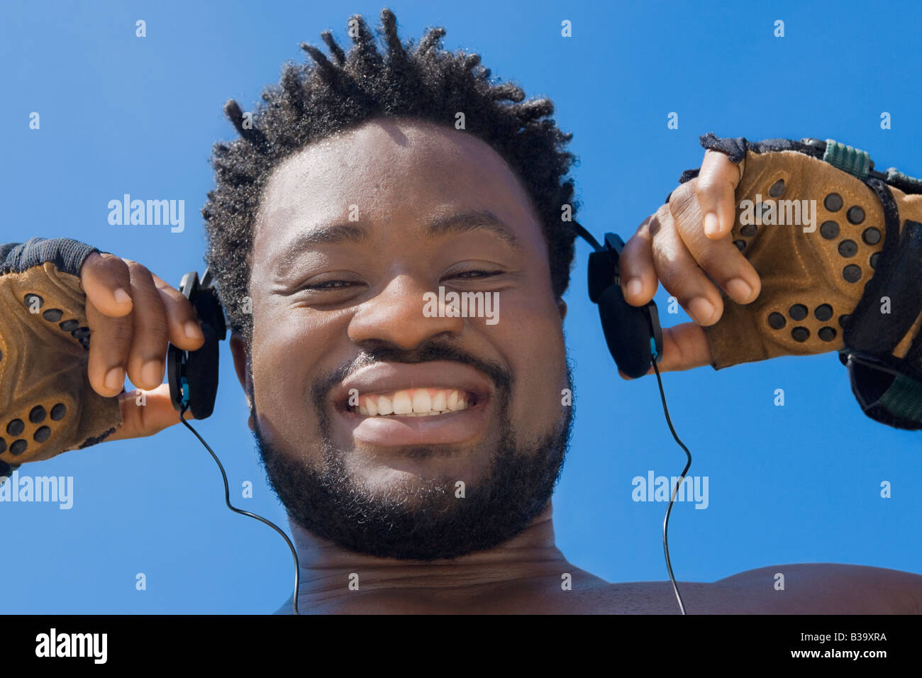 African man holding headphones Stock Photo - Alamy