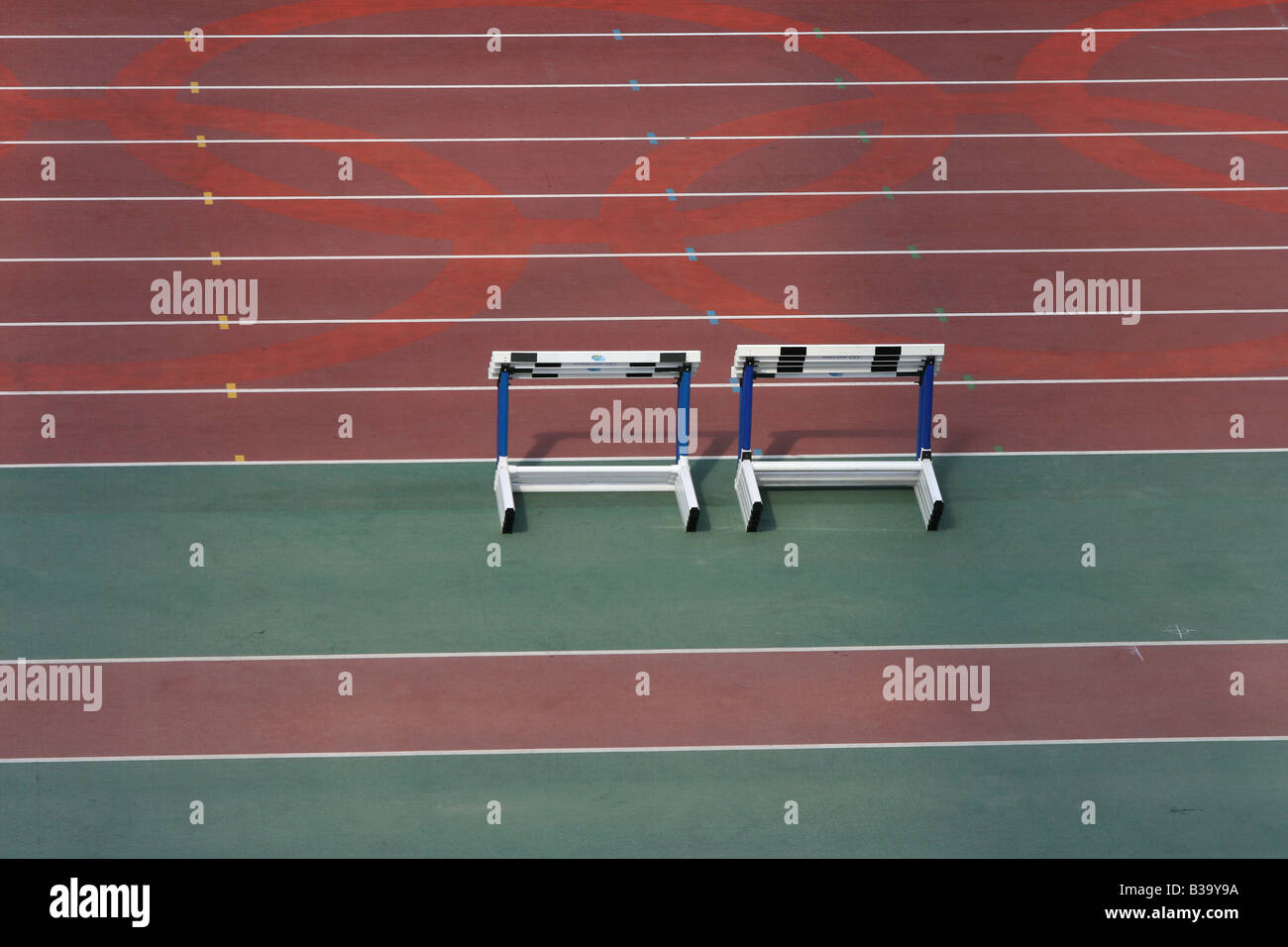detail from empty athletics race track and stack of hurdles Stock Photo ...