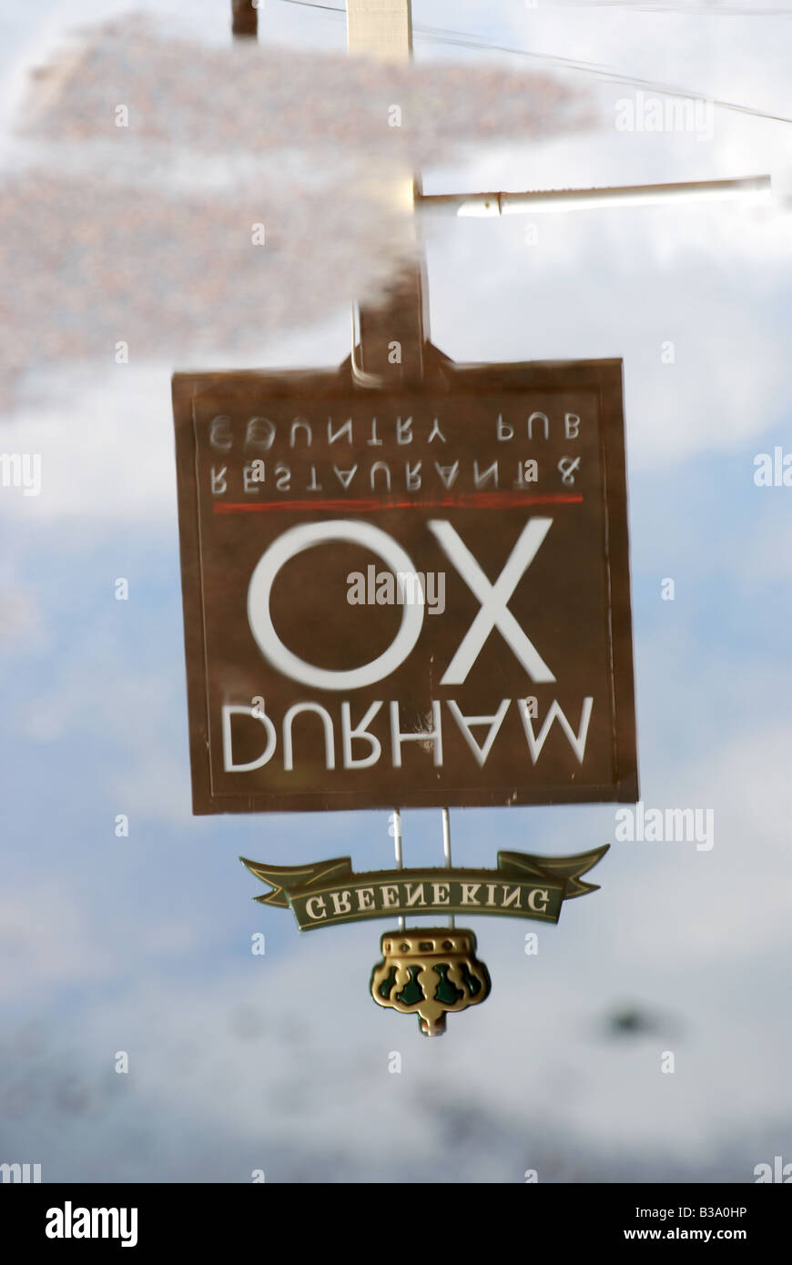 Durham Ox pub sign reflected in puddle, Shrewley, Warwickshire, England ...