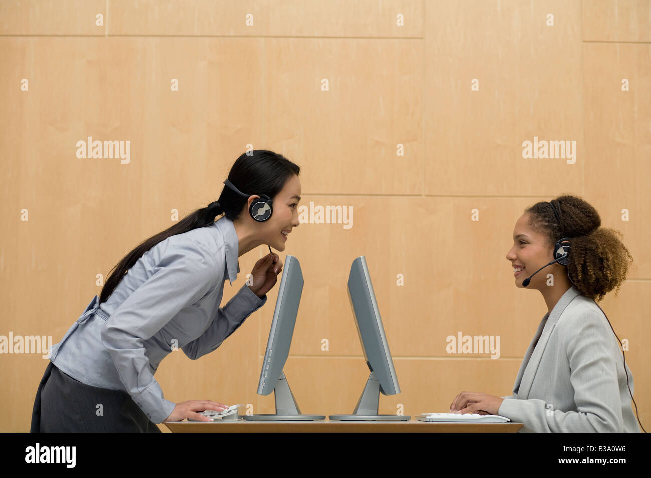 Two business people wearing headsets hi-res stock photography and ...