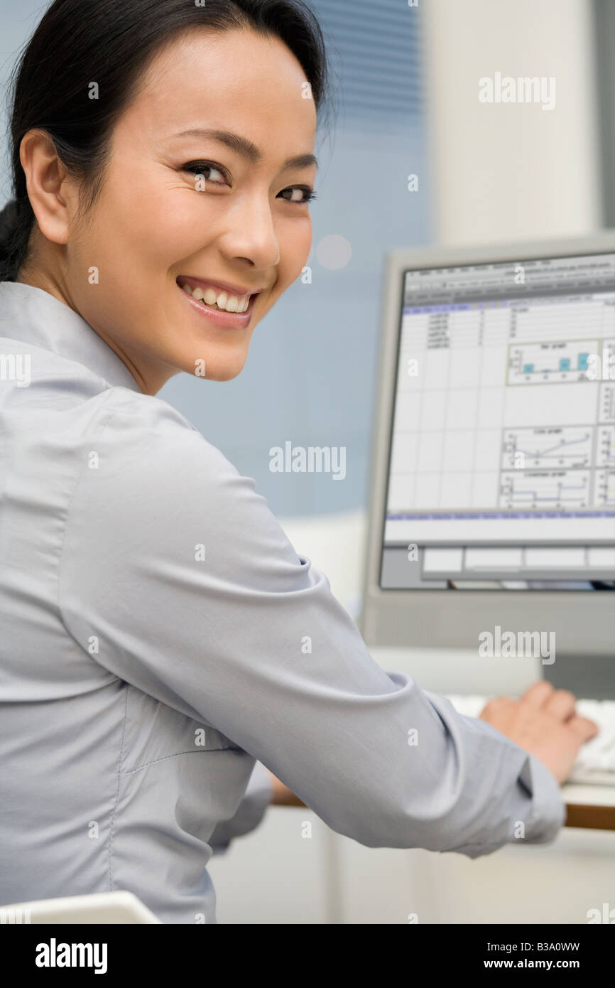 Asian businesswoman typing on computer Stock Photo - Alamy