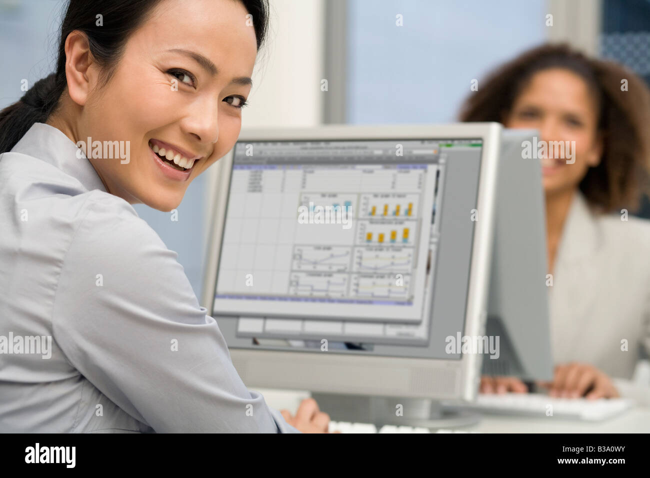 Asian businesswoman typing on computer Stock Photo - Alamy
