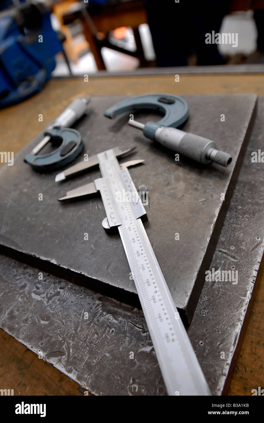 Precision measuring calipers and micrometers on an engineering workshop ...