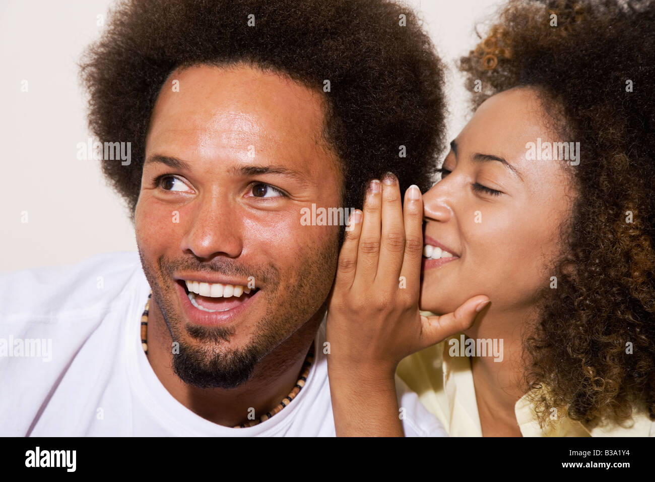 African couple telling secret Stock Photo - Alamy