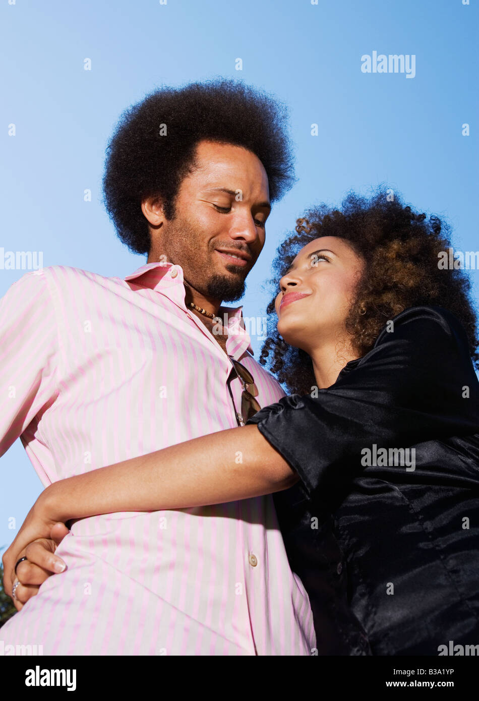 African couple hugging Stock Photo - Alamy