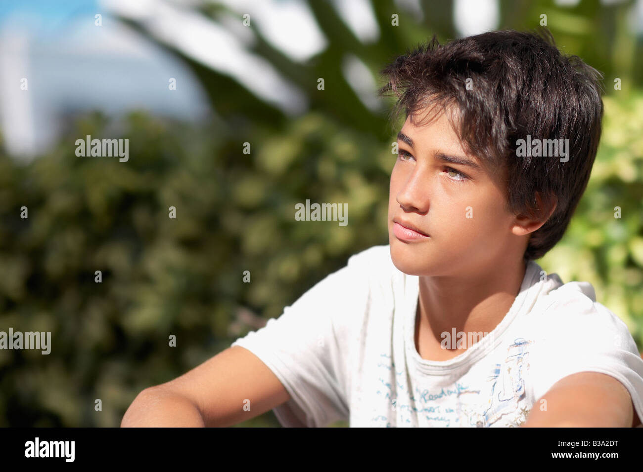 Pacific Islander boy sitting outdoors Stock Photo - Alamy