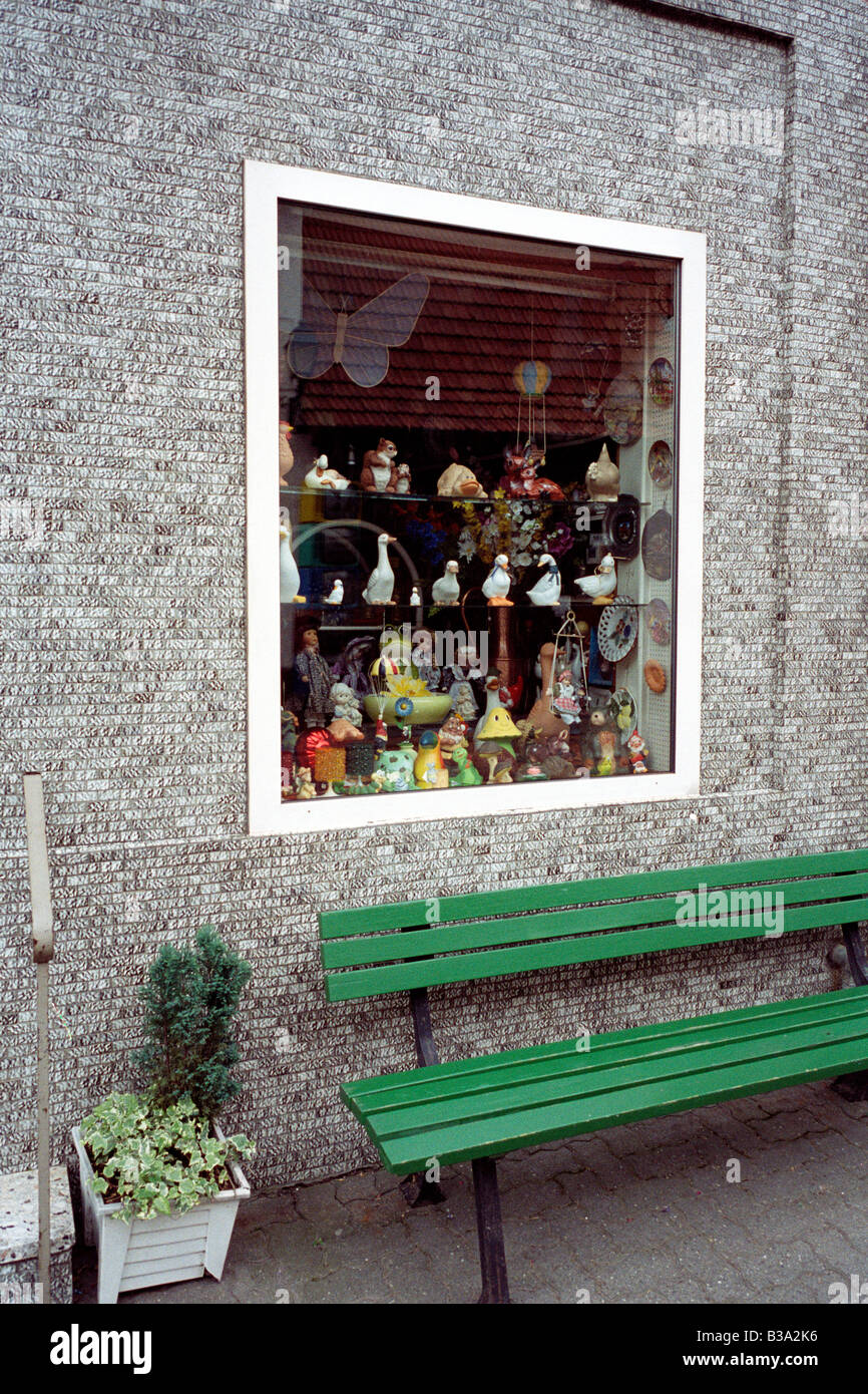 Shop window with green bench Stock Photo - Alamy