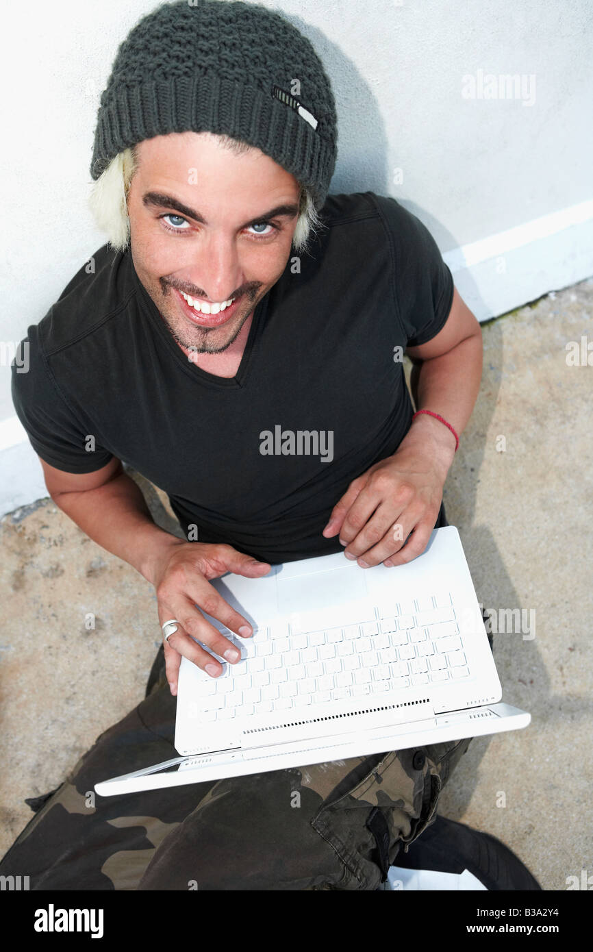 Hispanic man holding laptop Stock Photo - Alamy