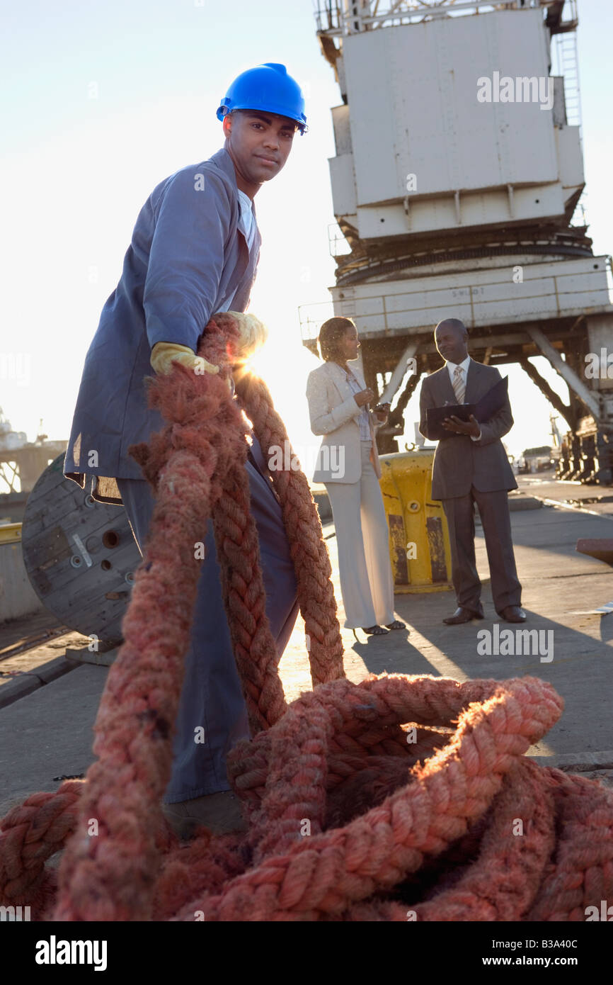 African American manual worker pulling rope Stock Photo - Alamy