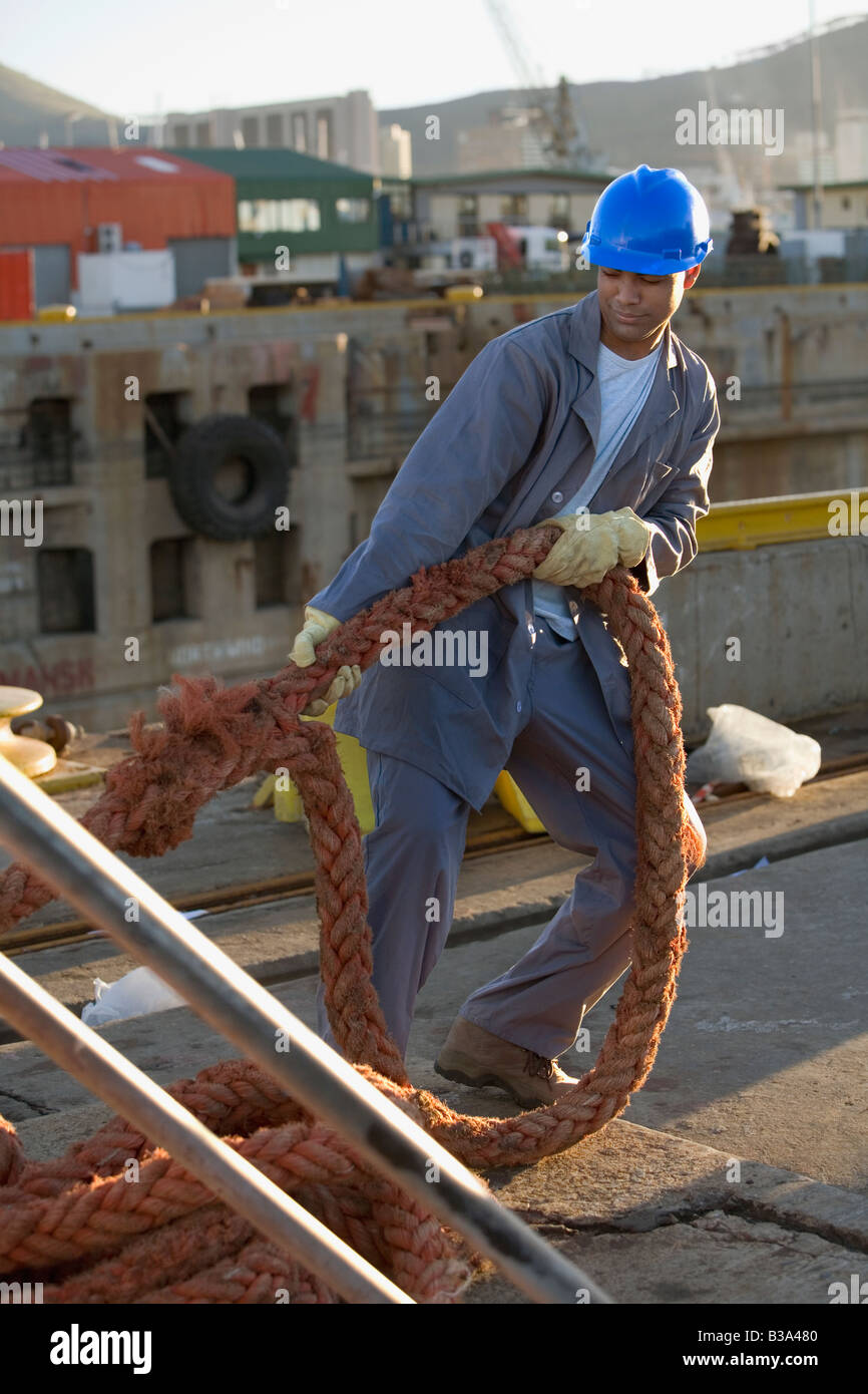 African American manual worker pulling on rope Stock Photo - Alamy