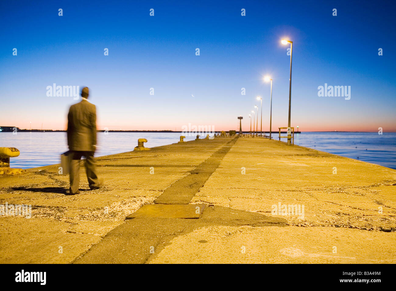 African American businessman walking on commercial pier Stock Photo - Alamy