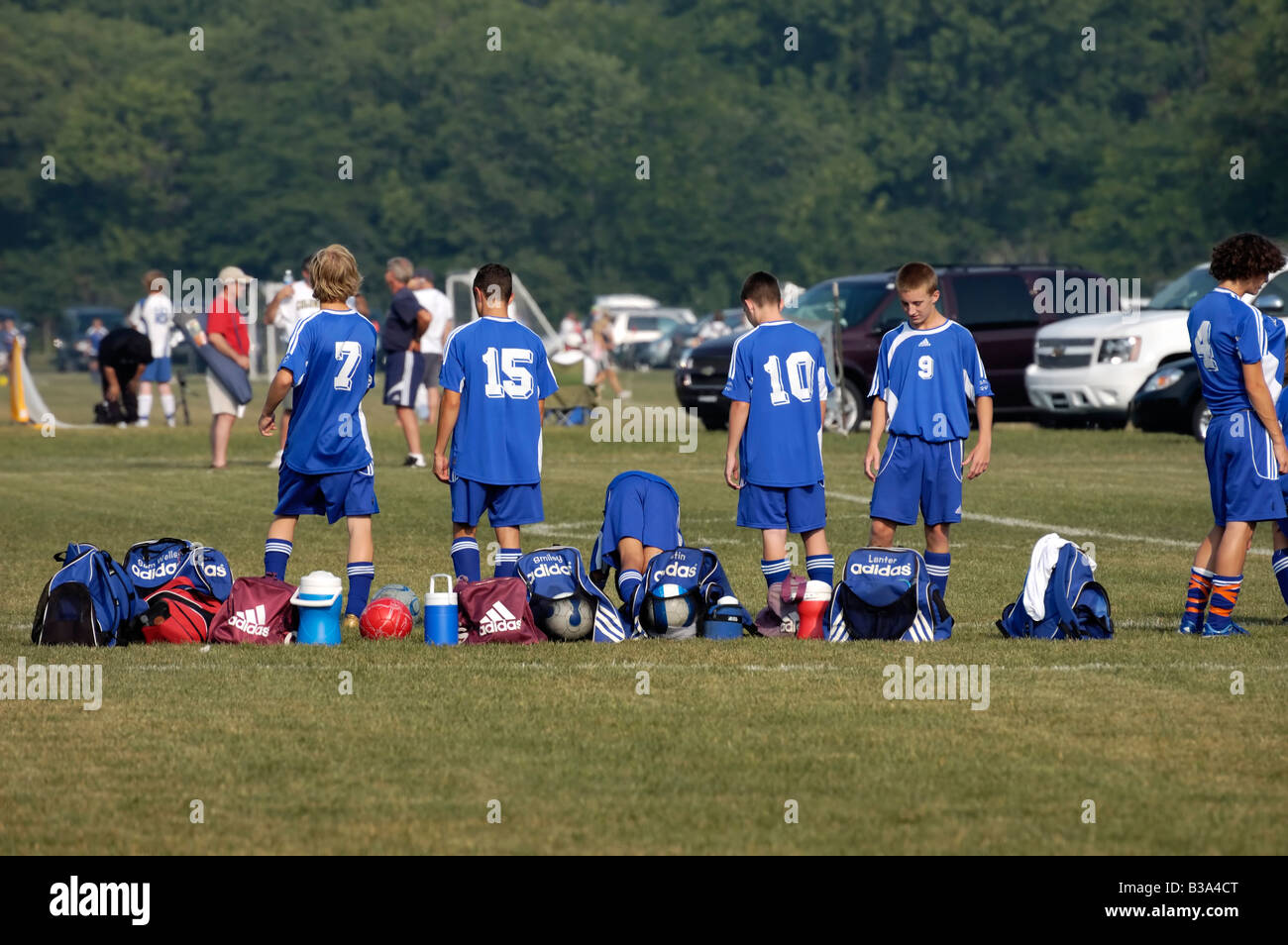 Teenage soccer players waiting for game to start Stock Photo - Alamy