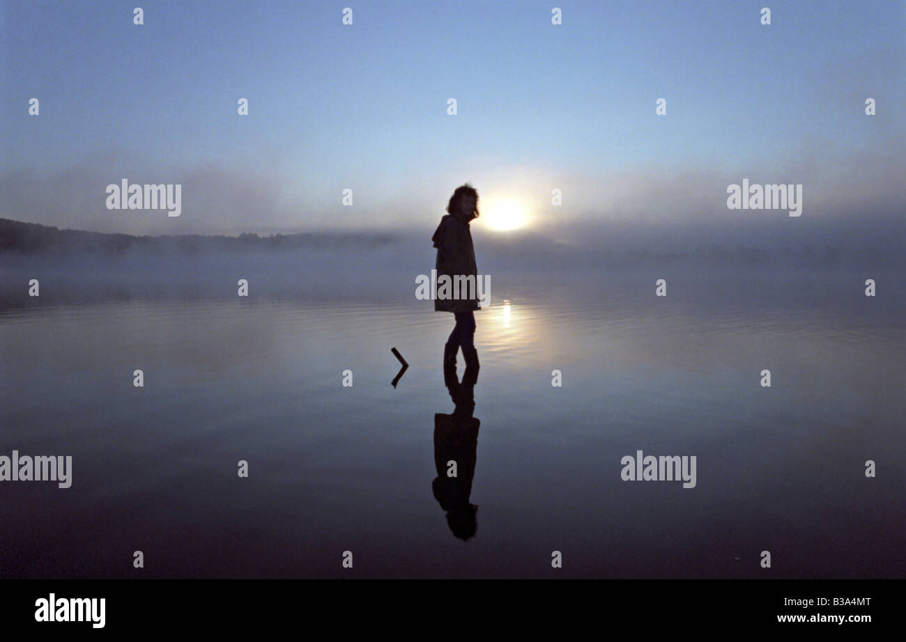 Woman wading in the lake Stock Photo - Alamy