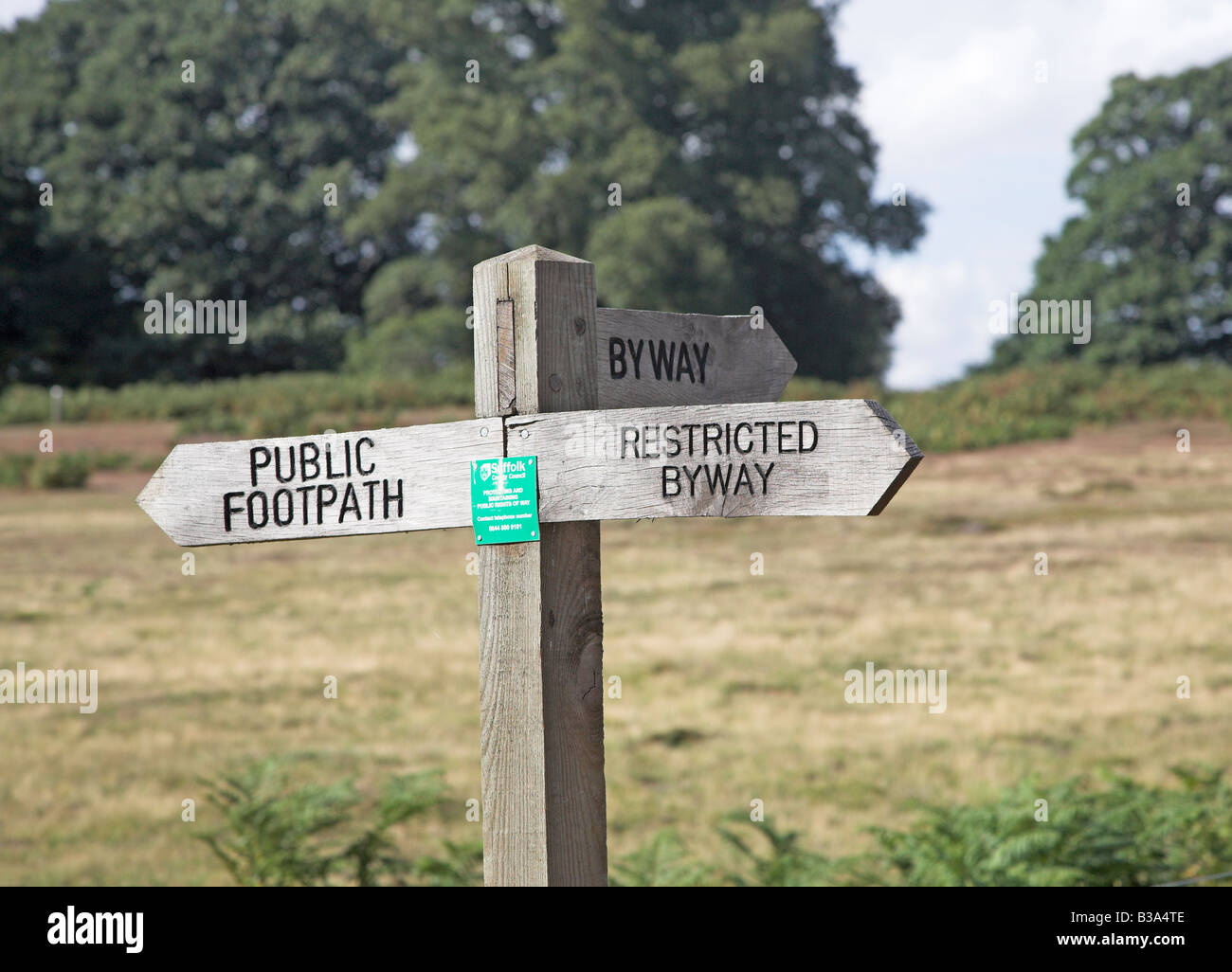 Public footpath byway wooden sign pointing three direction Stock Photo ...