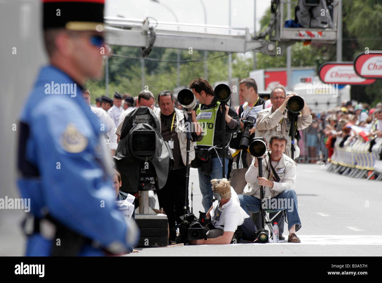 A local policeman looks on while the media wait for the next time trial ...
