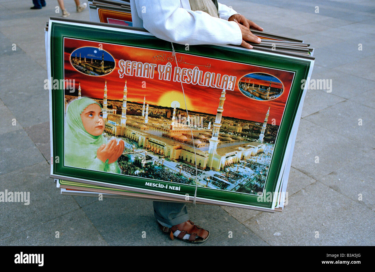 Man in Istanbul selling posters of Mecca Stock Photo - Alamy