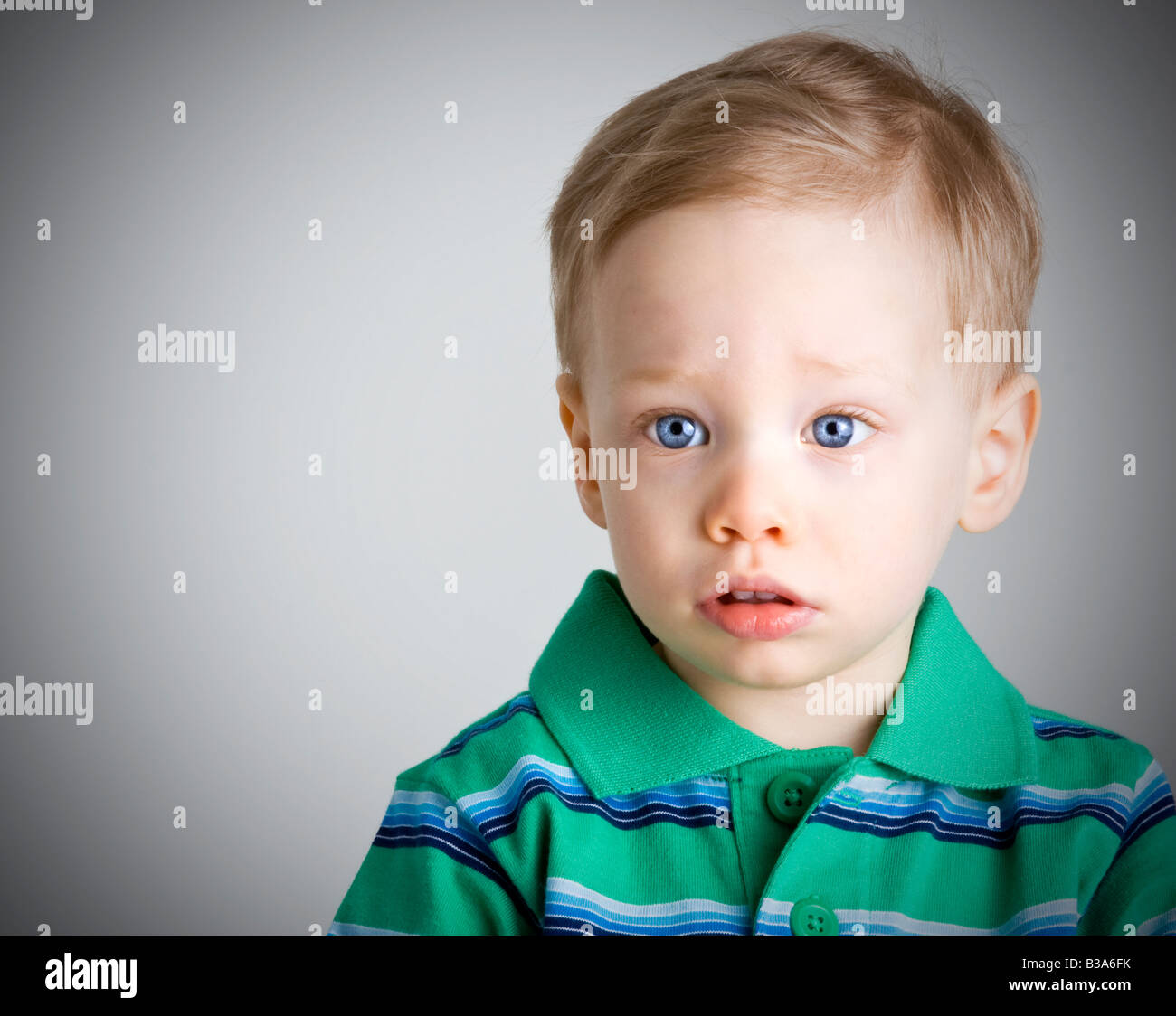 Sad boy with big blue eyes looking away from the camera Stock Photo - Alamy