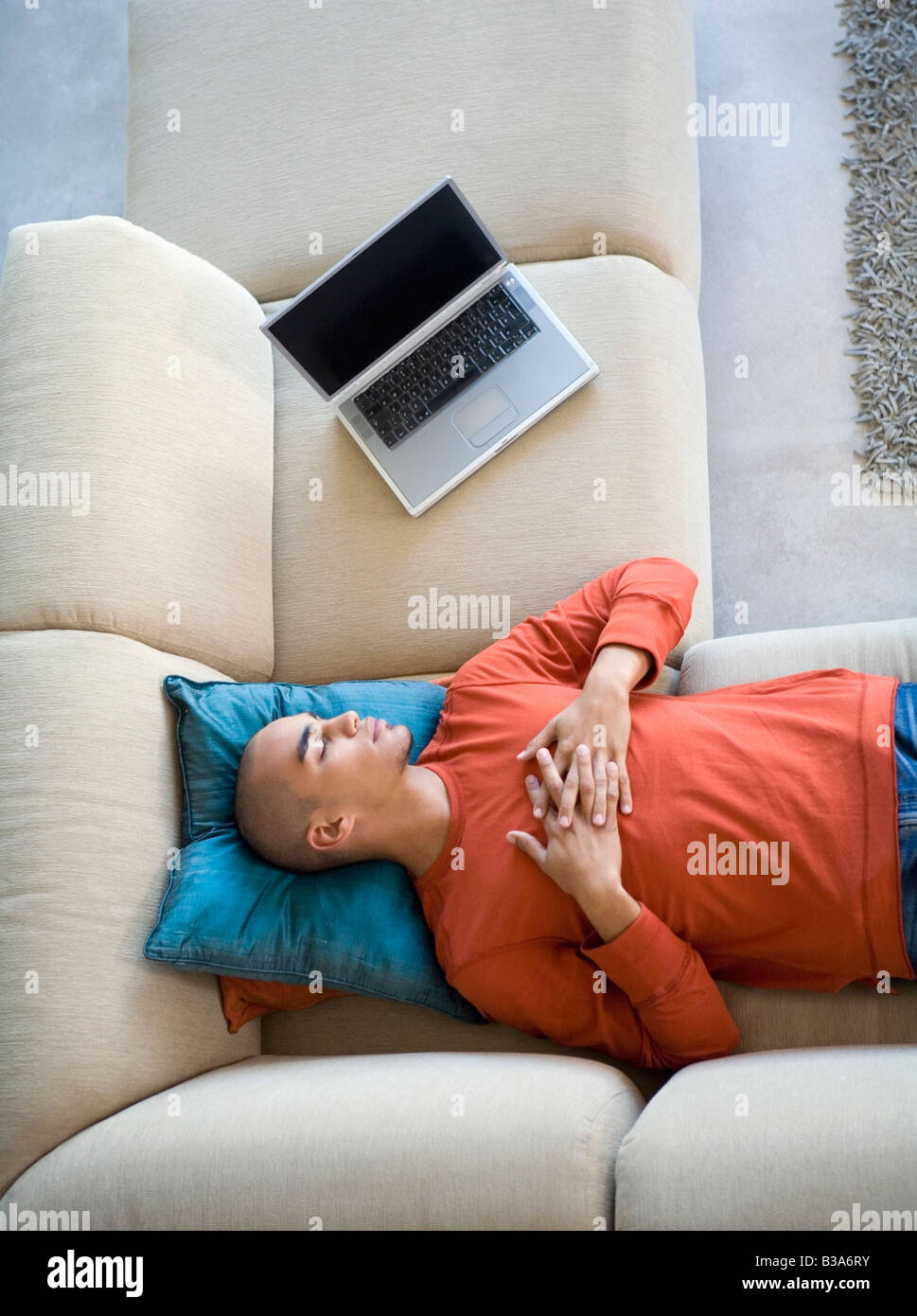 African American man sleeping on sofa Stock Photo - Alamy