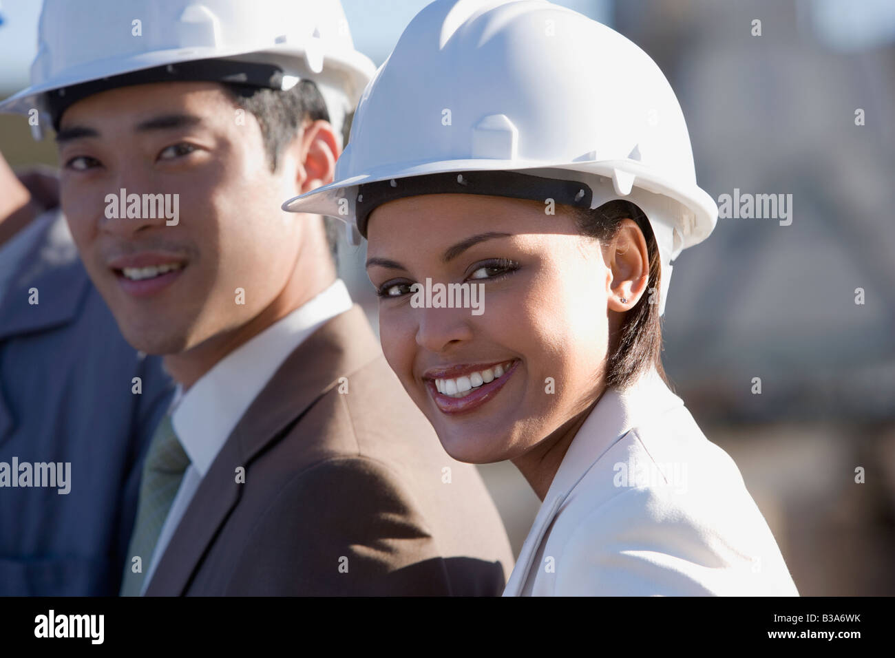 Multi-ethnic businesspeople wearing hardhats Stock Photo - Alamy