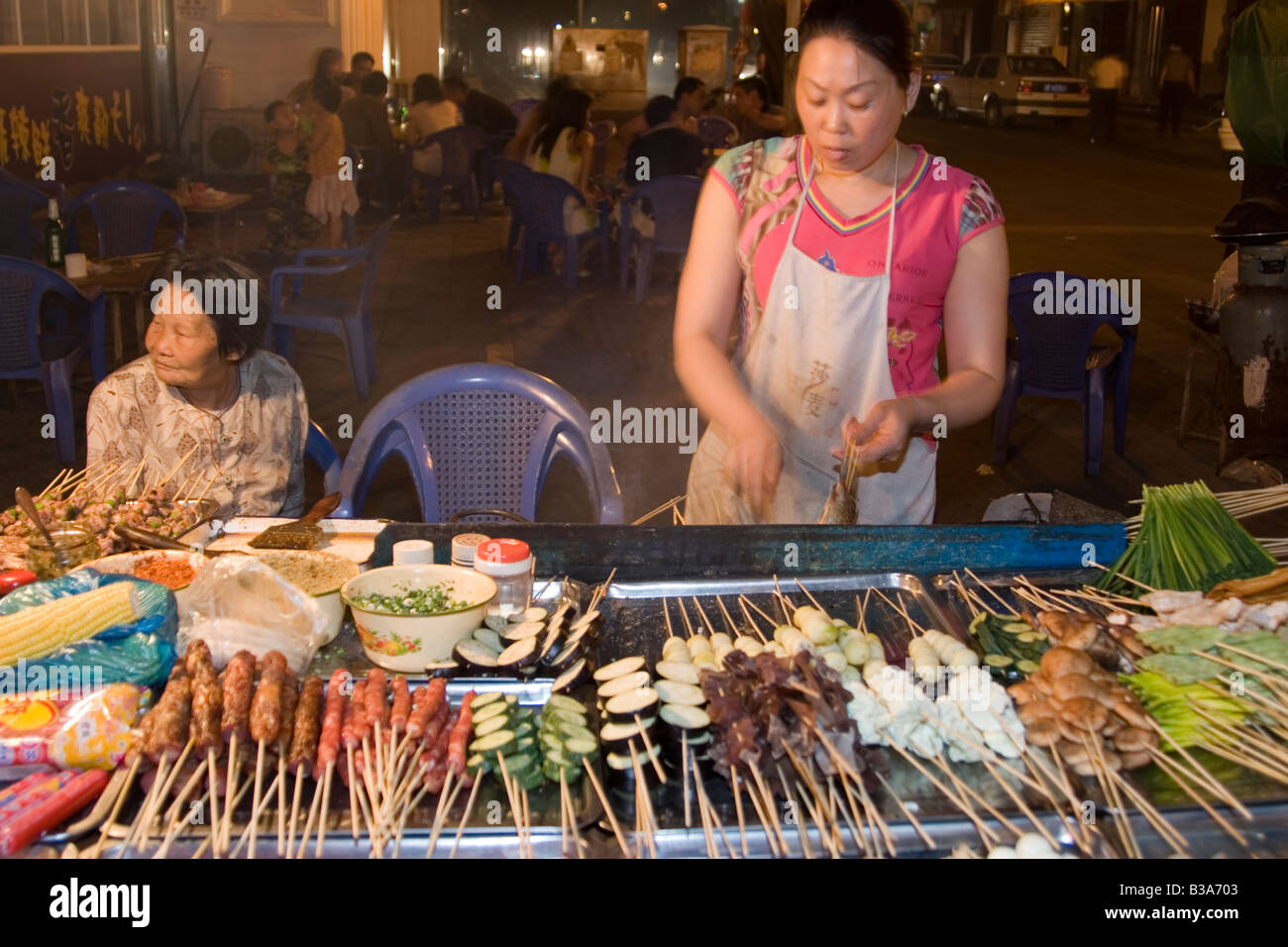 Street-side barbecues or grills are famous late at night in towns ...